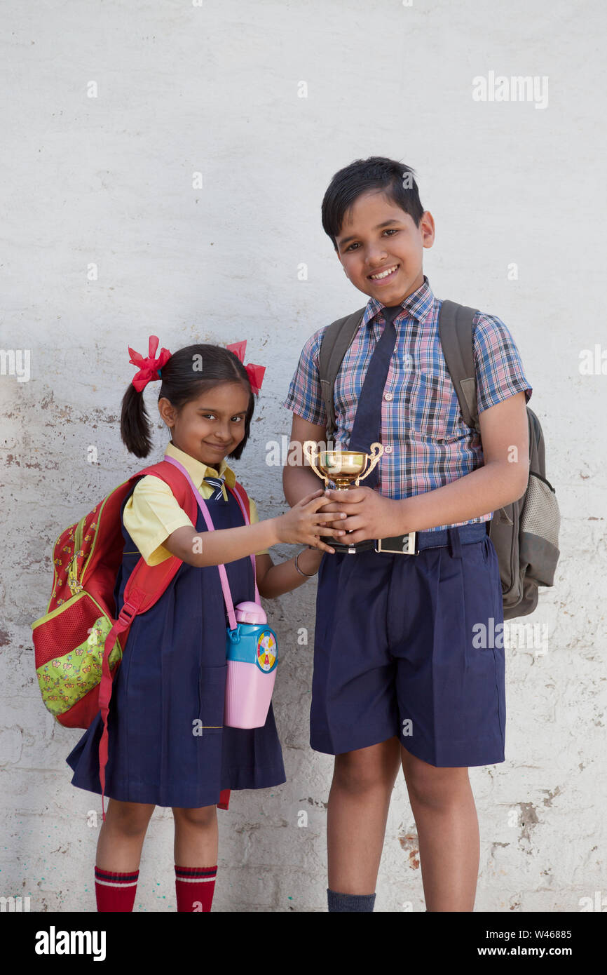 Portrait of students holding trophy Stock Photo - Alamy