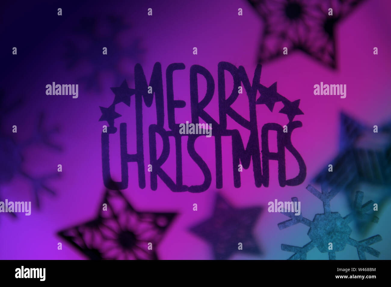 Merry Christmas message with hanging star ornaments Stock Photo - Alamy