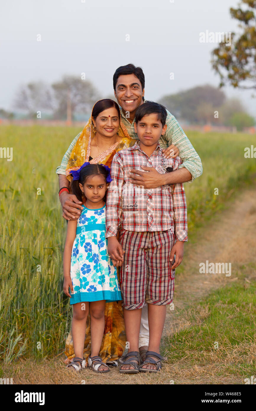 Rural family standing in a field Stock Photo - Alamy