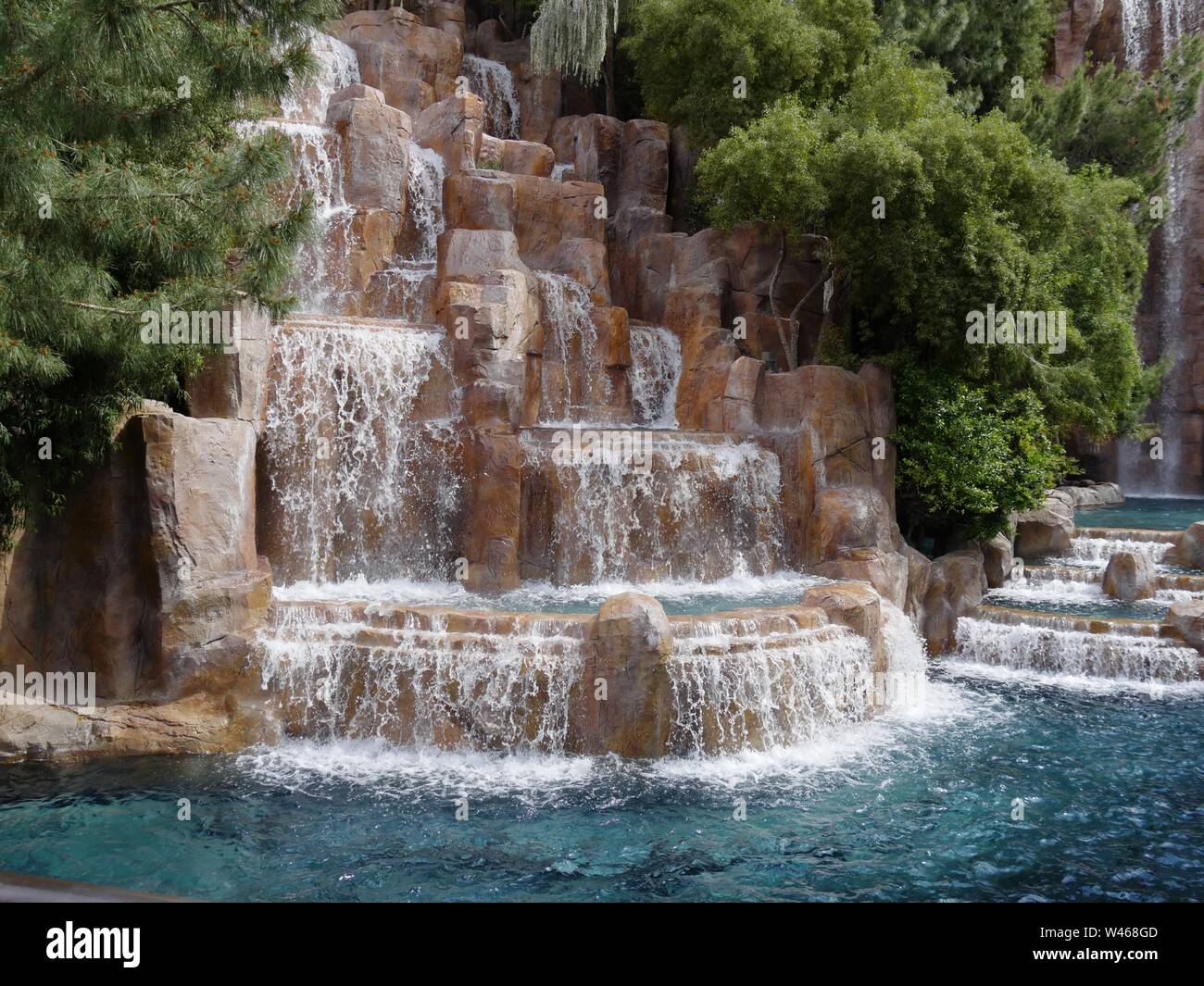 Man-made waterfalls in a landscaped garden Stock Photo - Alamy