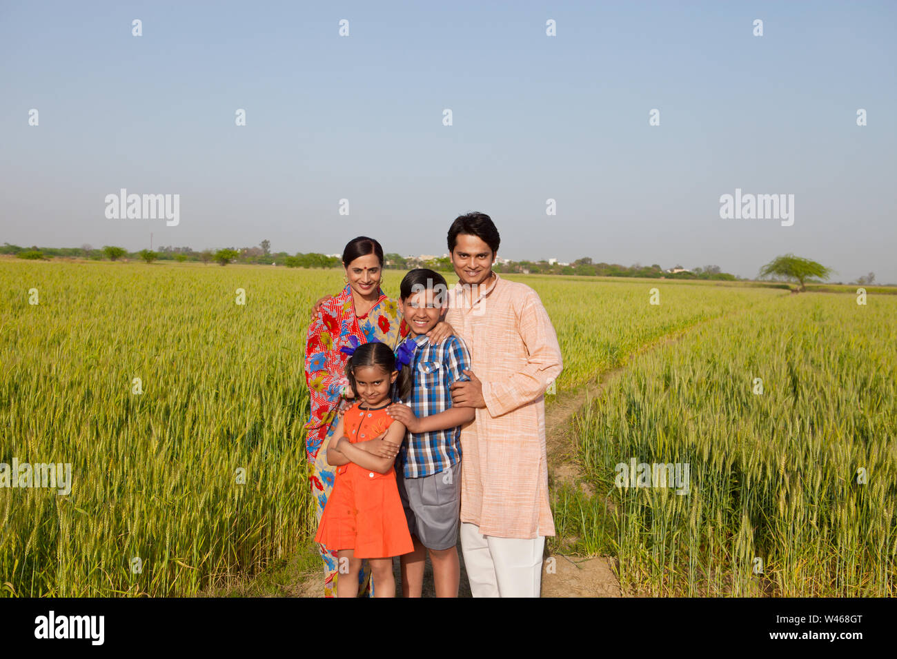 Rural family standing in a field Stock Photo - Alamy