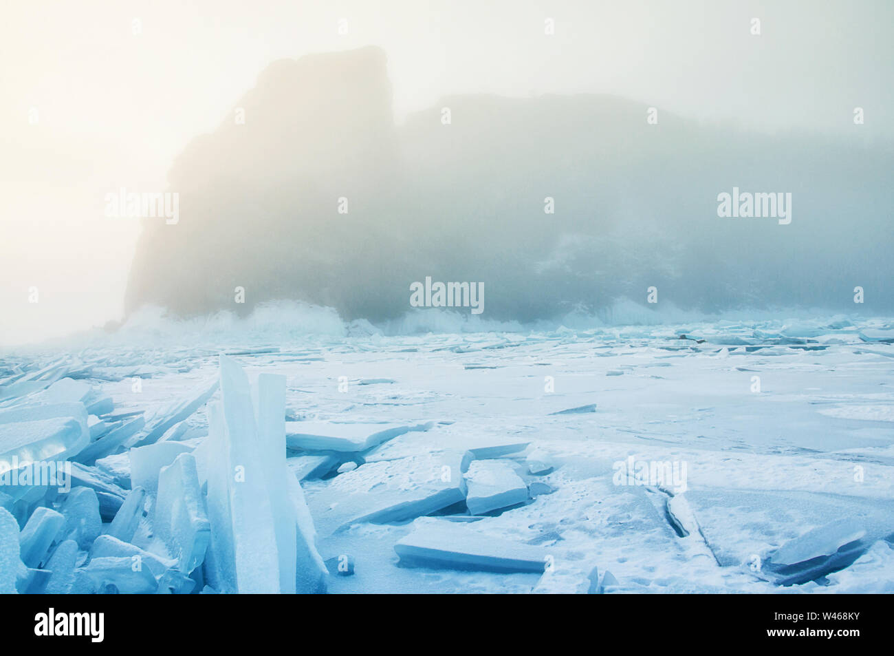 Field of blue ice and rocks with fog Stock Photo - Alamy