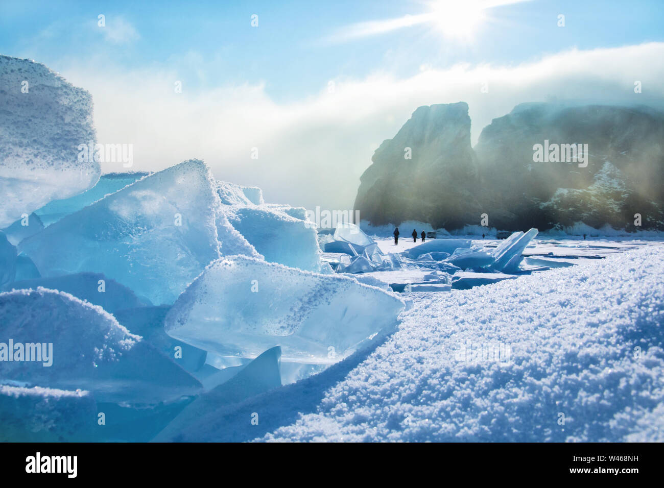 Field of blue ice and rocks with sun Stock Photo - Alamy