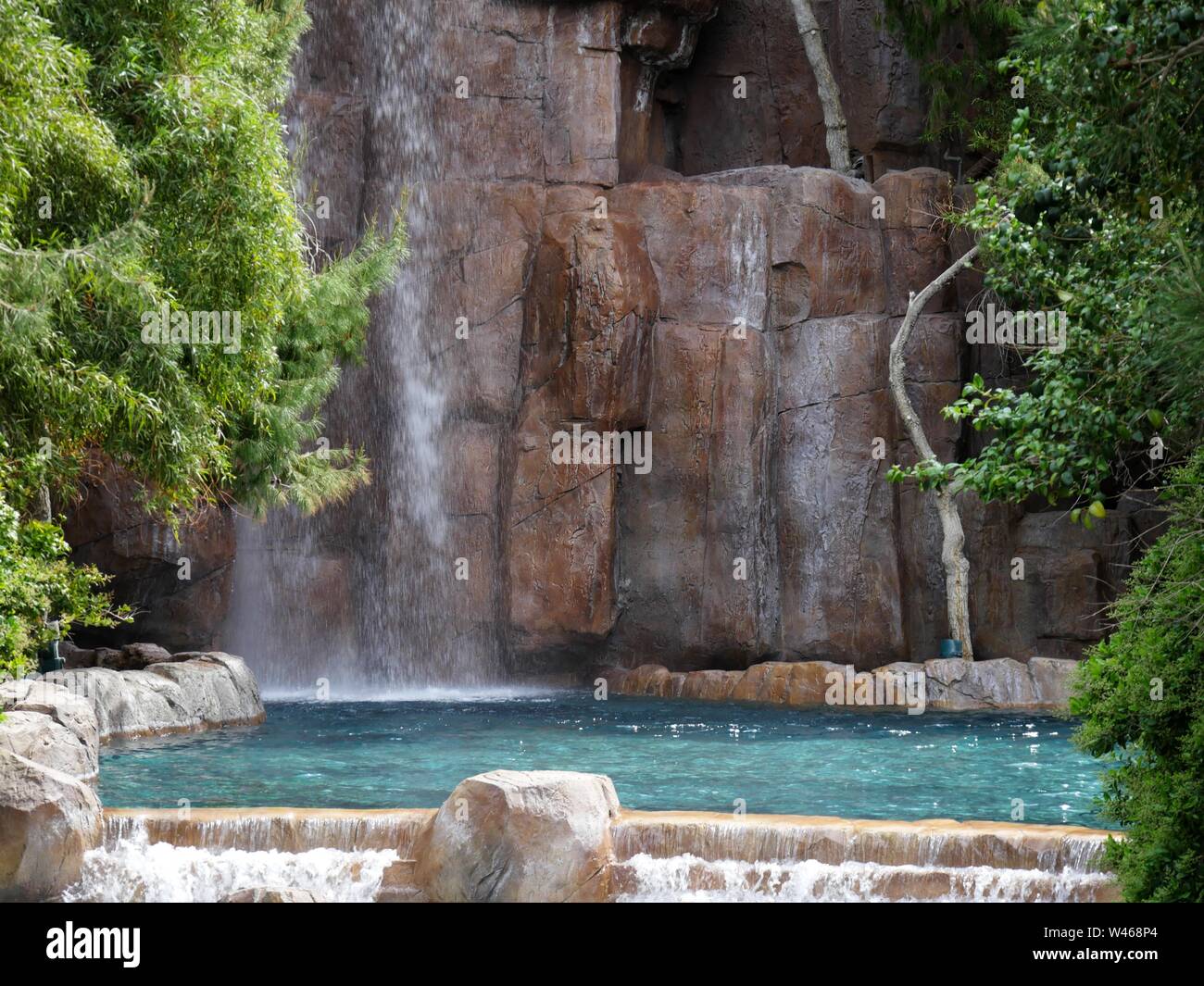 Blue waters of a pool with water cascading down a waterfalls Stock ...