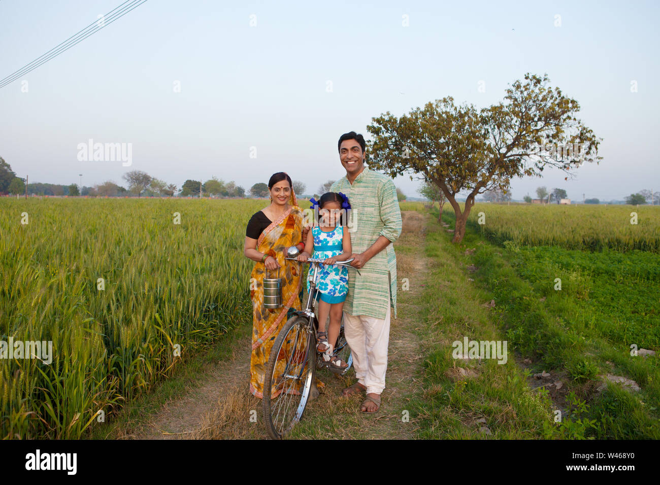 Rural family standing in a field Stock Photo - Alamy