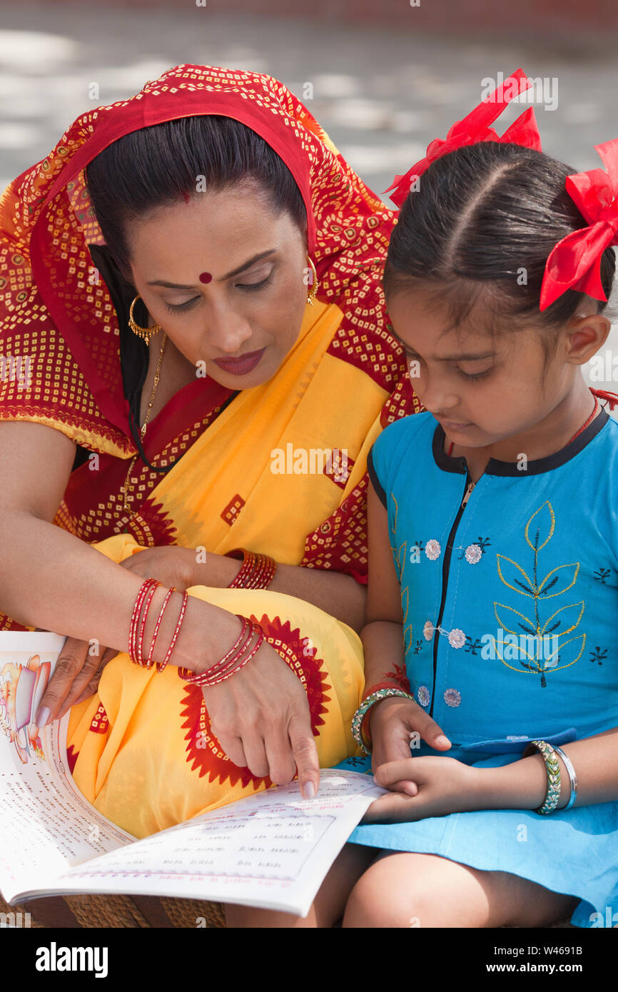 Woman teaching her daughter Stock Photo - Alamy
