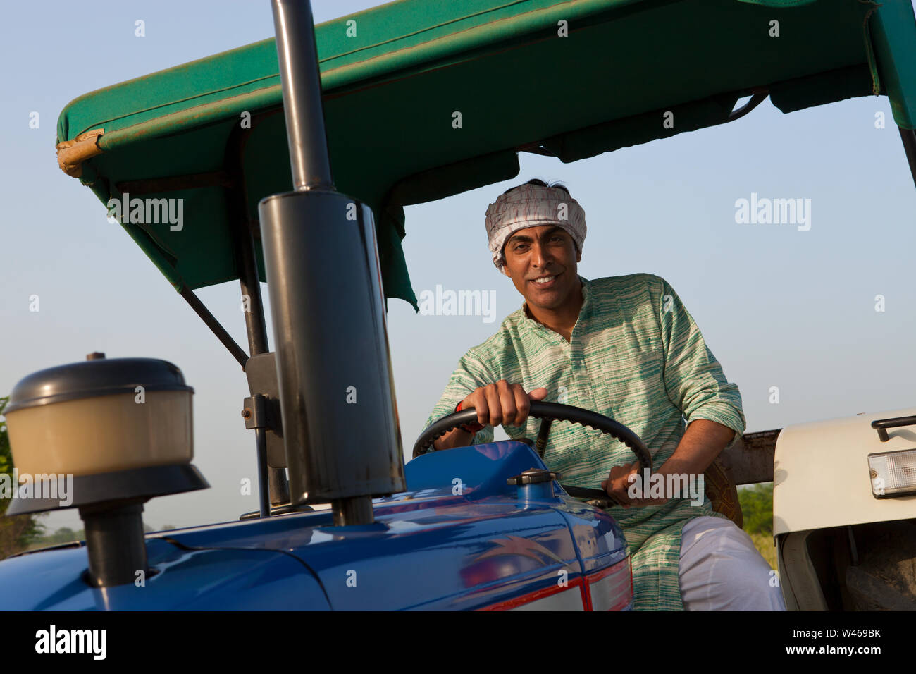Happy farmer driving tractor hi-res stock photography and images - Alamy