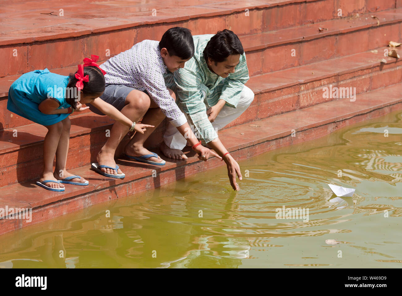 Family playing with paper boat Stock Photo - Alamy