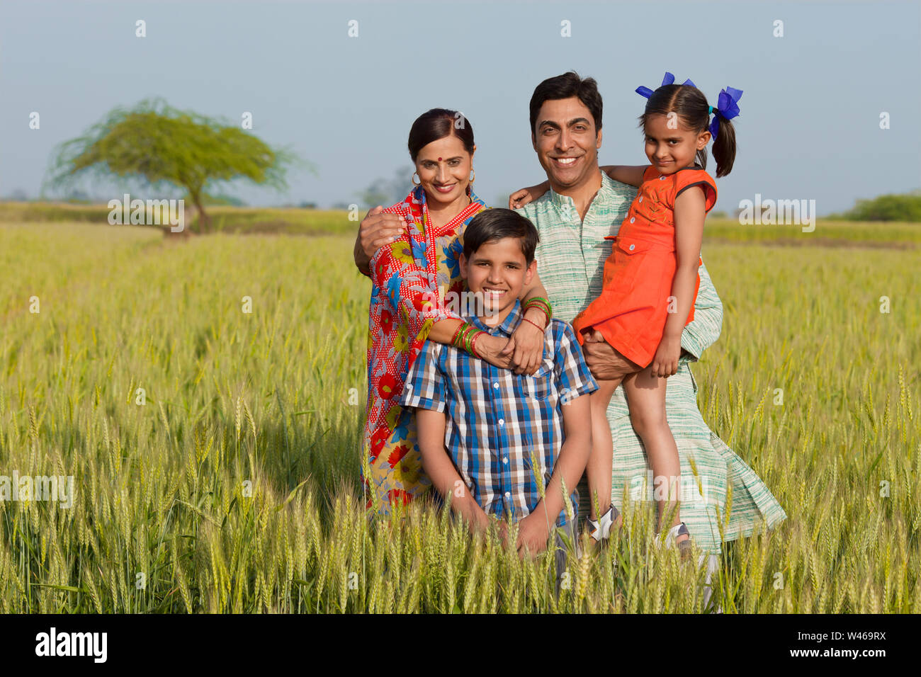 Rural family smiling in a field Stock Photo - Alamy