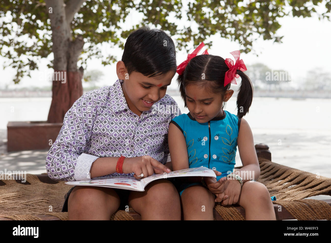 Boy teaching his sister Stock Photo - Alamy