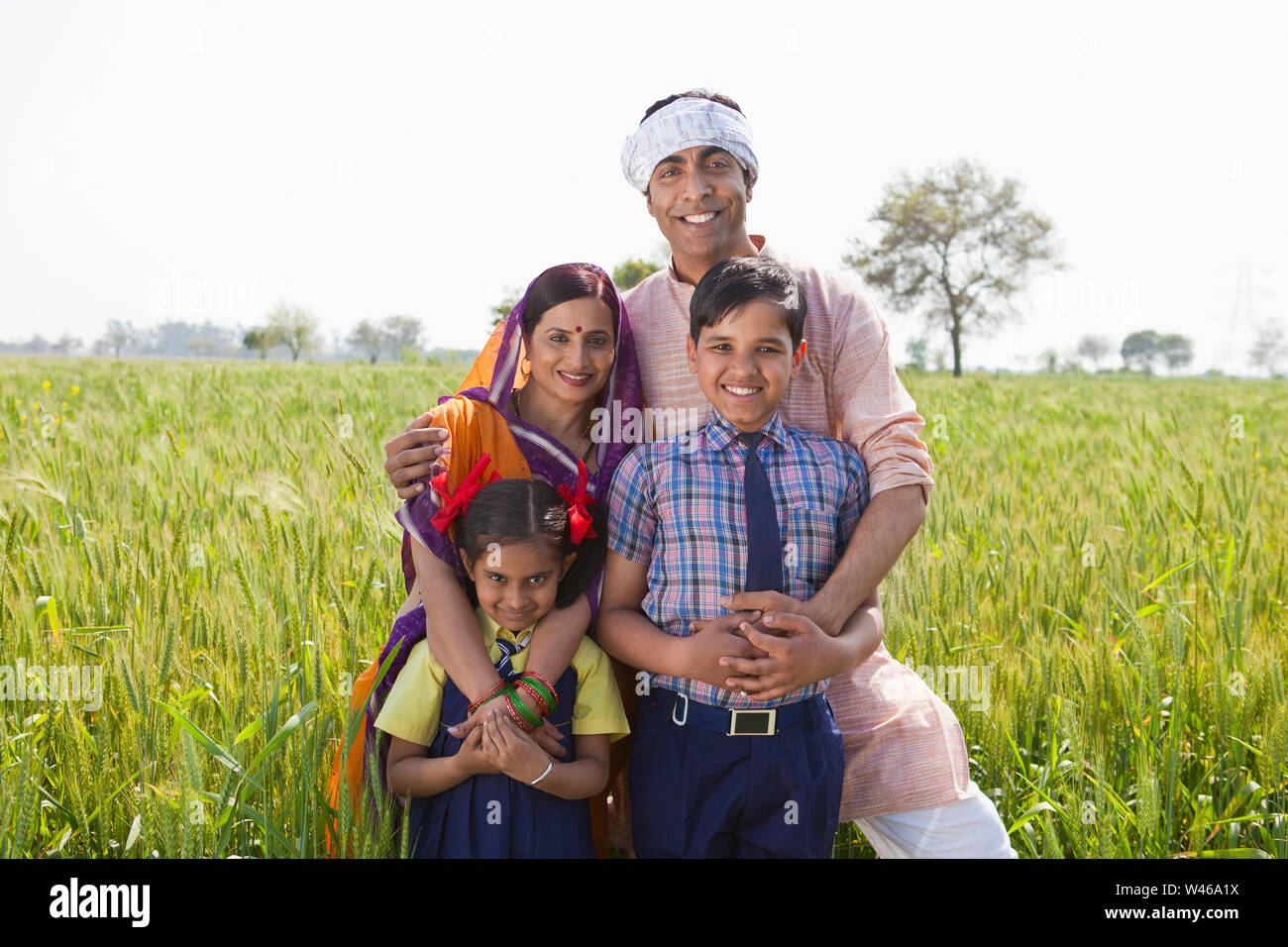 Rural family standing in a field and smiling Stock Photo - Alamy