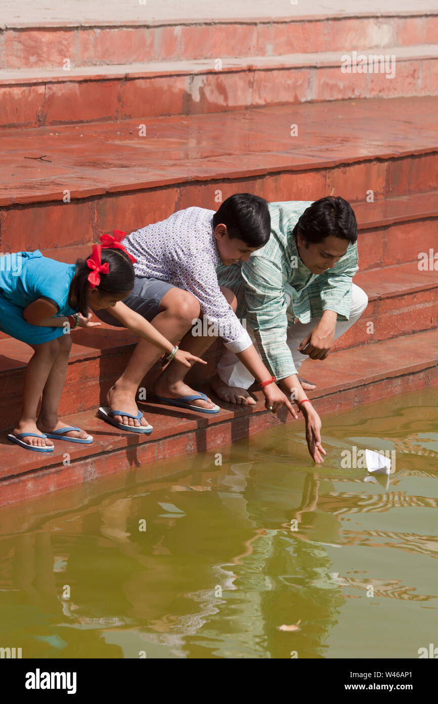 Family playing with paper boat Stock Photo - Alamy