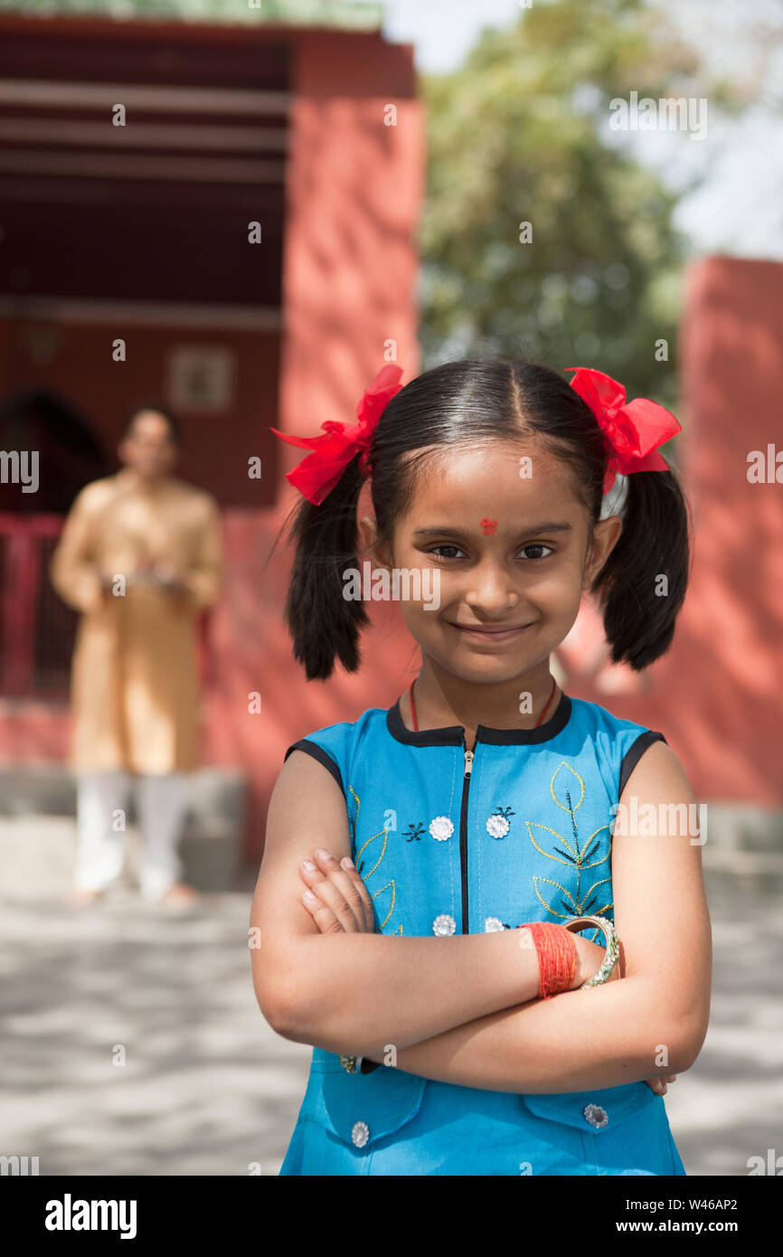 Portrait of a girl standing with her arms crossed Stock Photo - Alamy