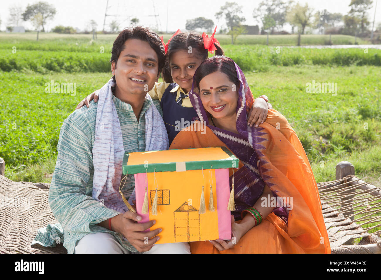 Family showing dream home and smiling Stock Photo - Alamy