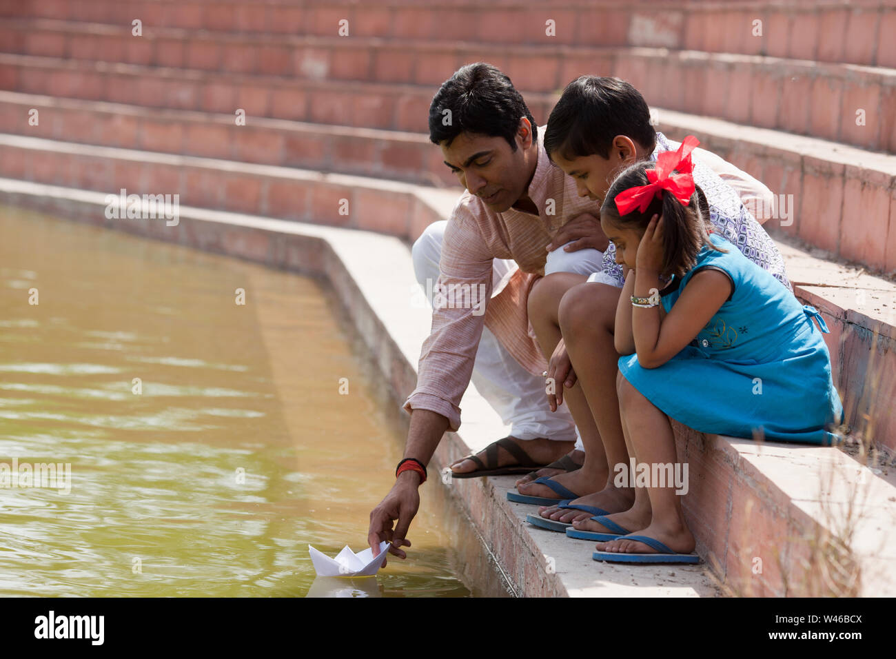 Family playing with paper boat Stock Photo - Alamy