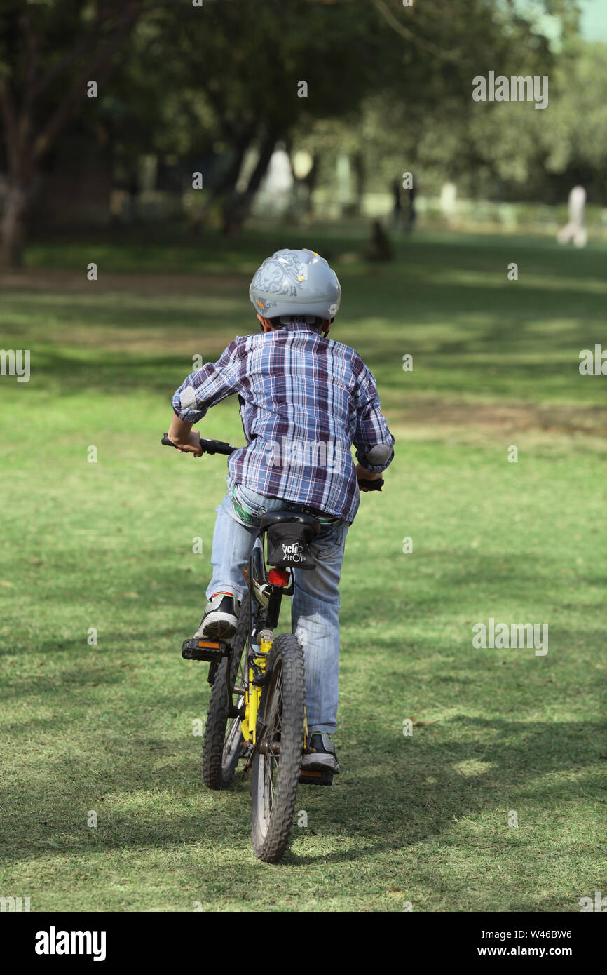 Boy riding cycle in the park Stock Photo - Alamy