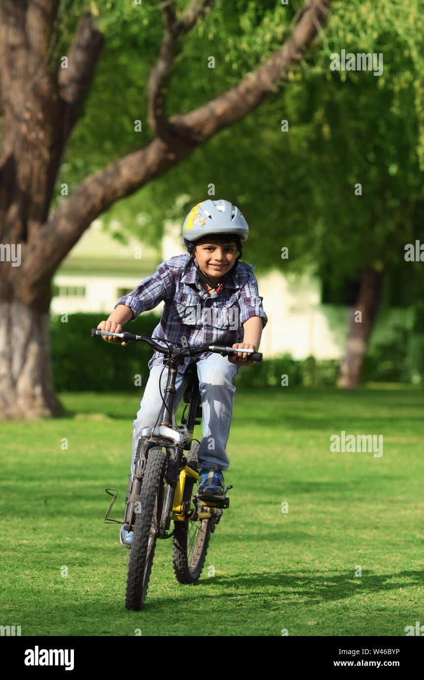 Boy riding cycle in the park Stock Photo - Alamy