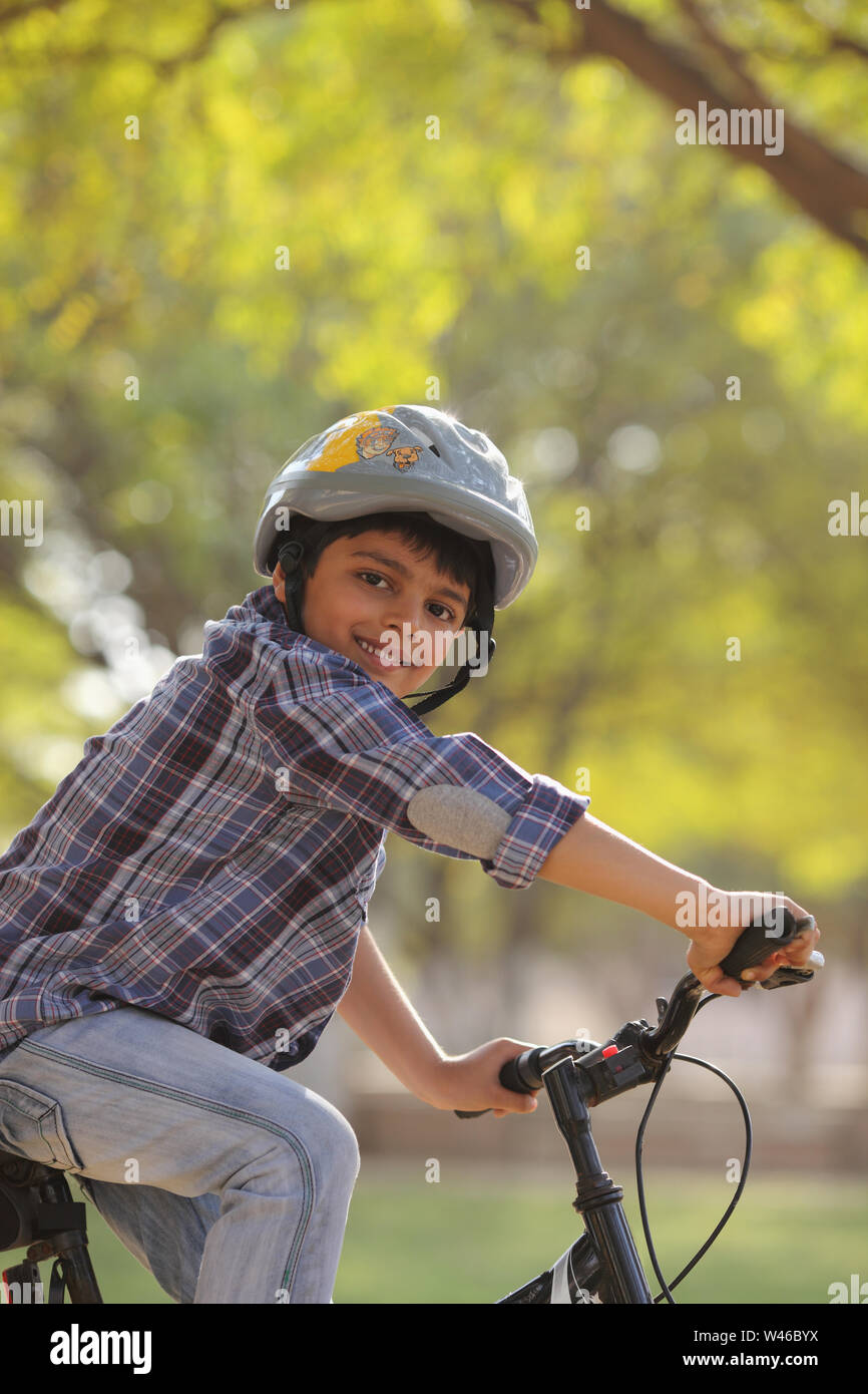 Boy riding cycle in the park Stock Photo - Alamy