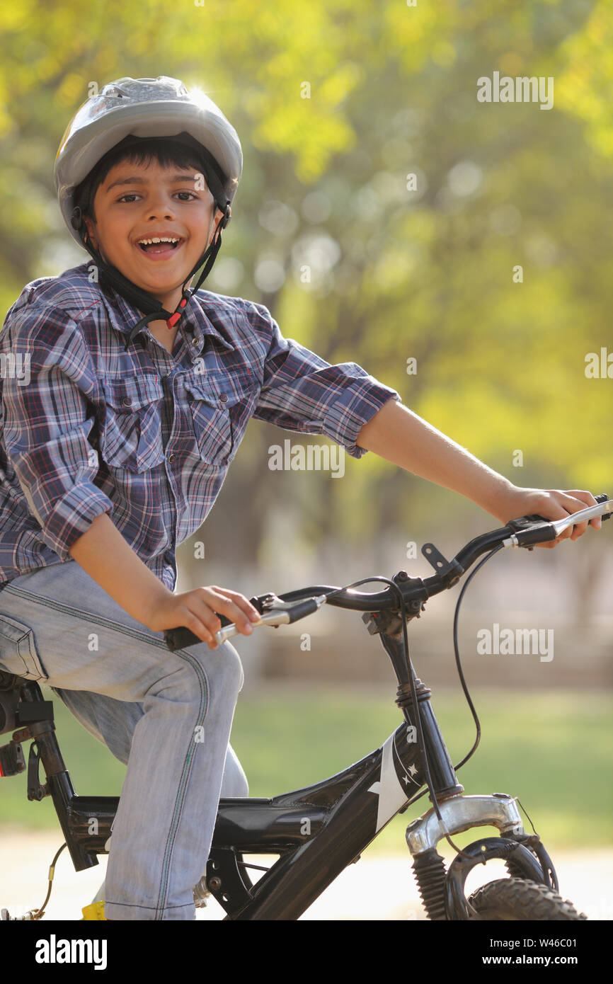 Boy riding cycle in the park Stock Photo - Alamy
