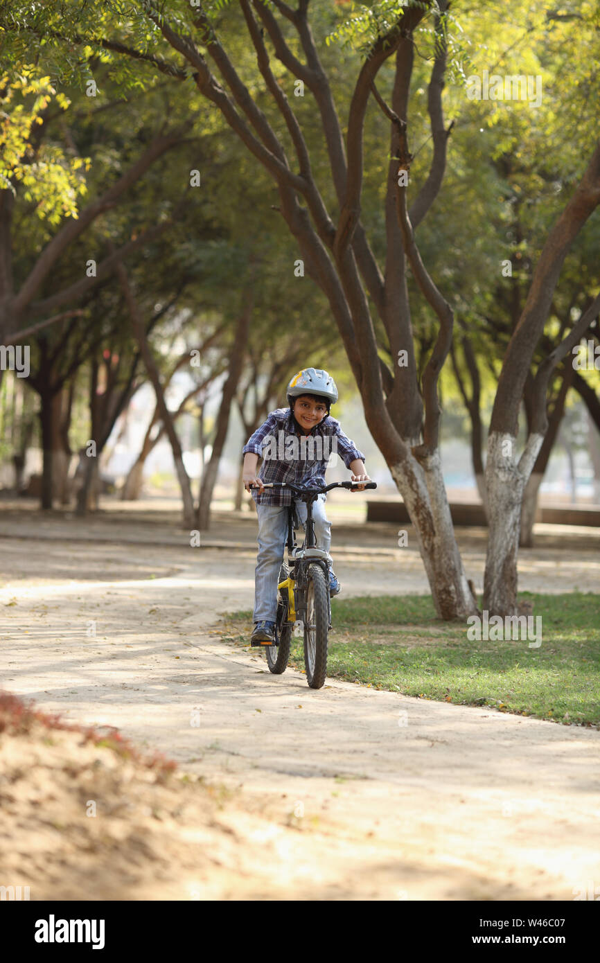 Boy riding cycle in the park Stock Photo - Alamy