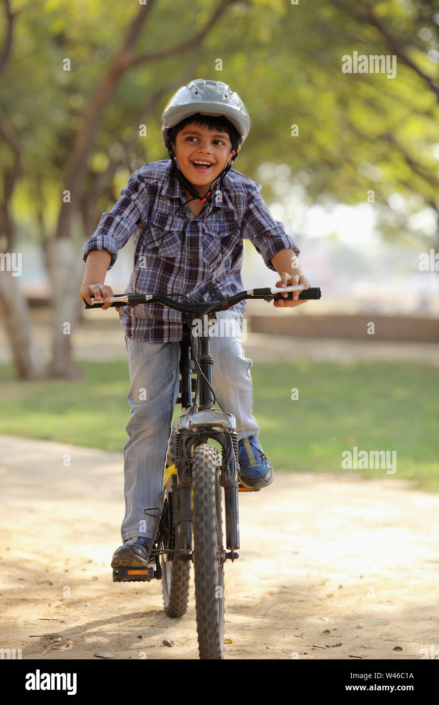 Boy riding cycle in the park Stock Photo - Alamy