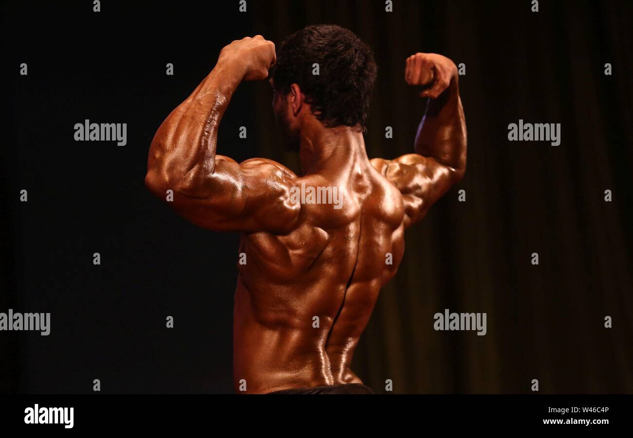 A bodybuilder poses during the 12th South Asian Bodybuilding ...