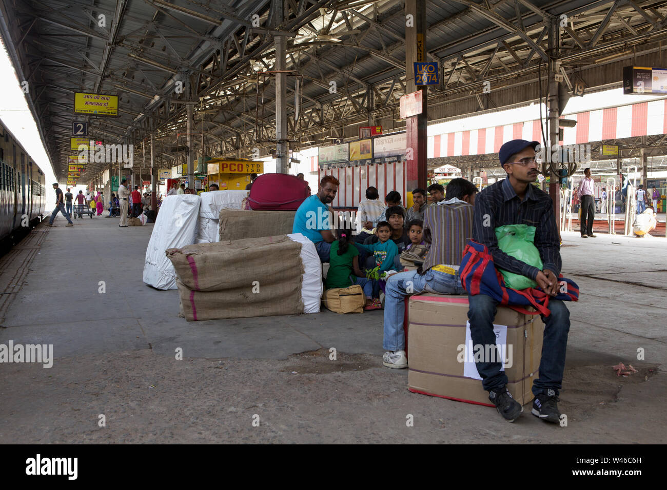 Passengers waiting at a station platform Stock Photo - Alamy