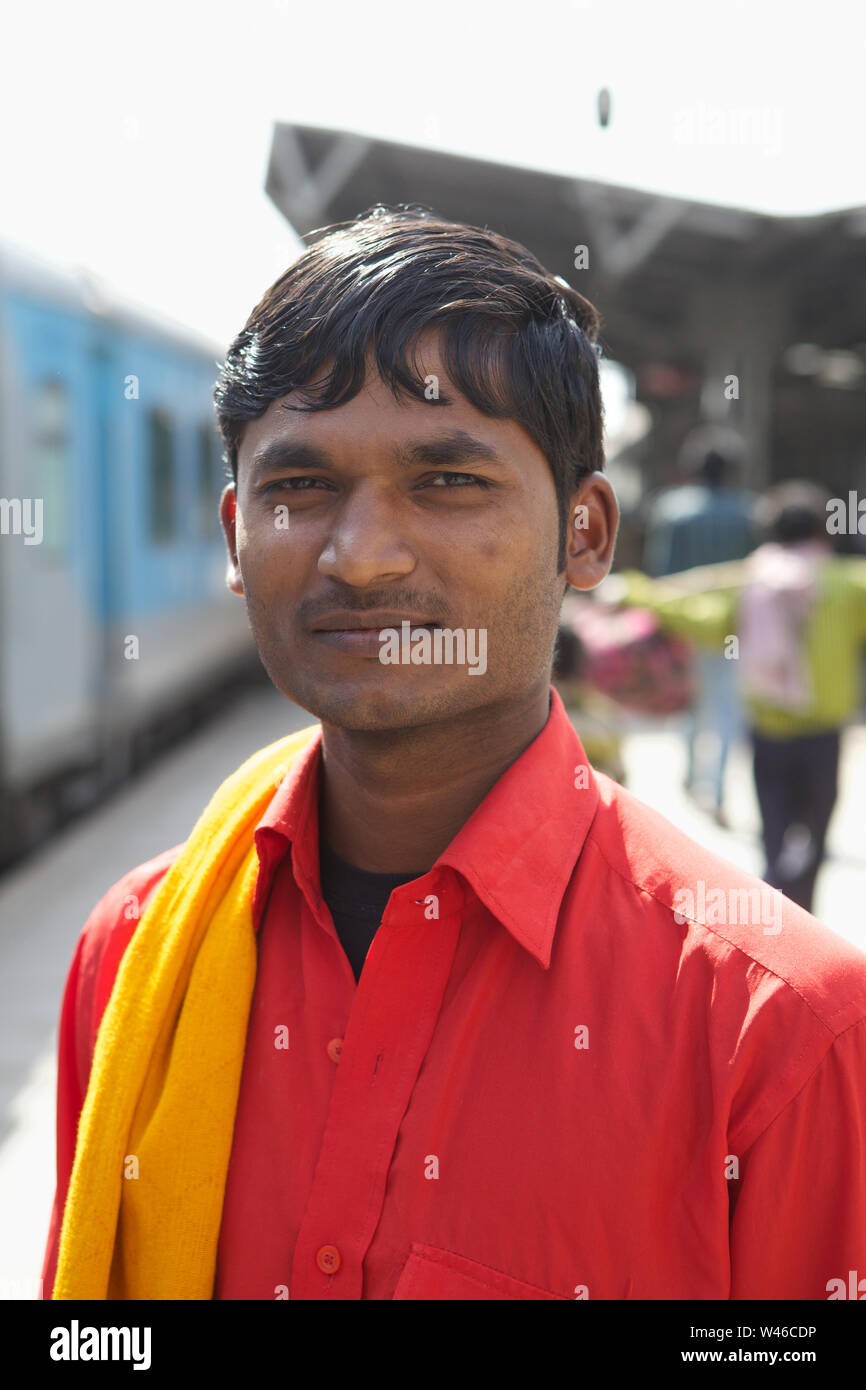 Portrait of a coolie at a station platform Stock Photo - Alamy