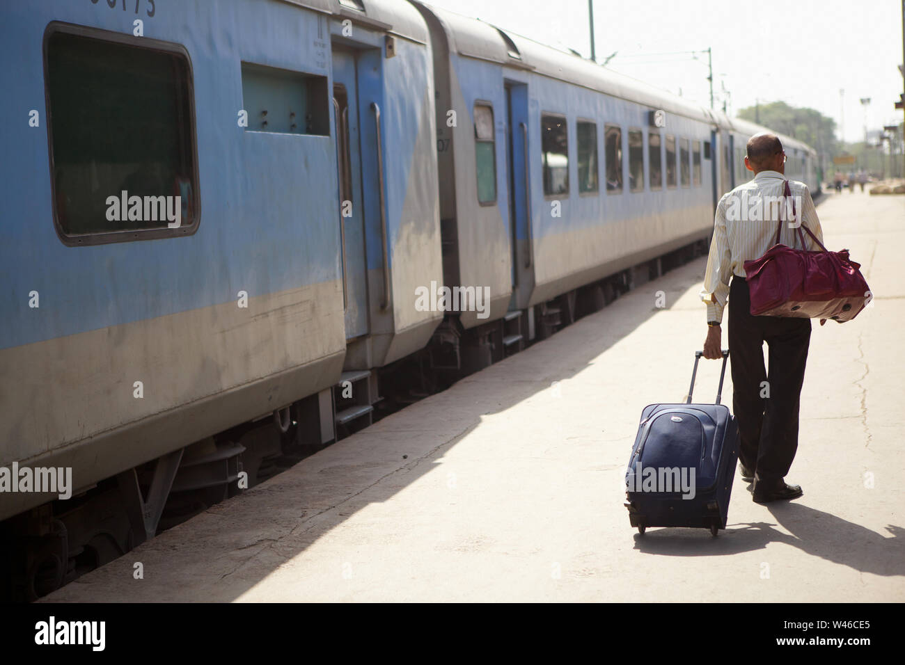 Passenger pulling luggage at a platform Stock Photo - Alamy