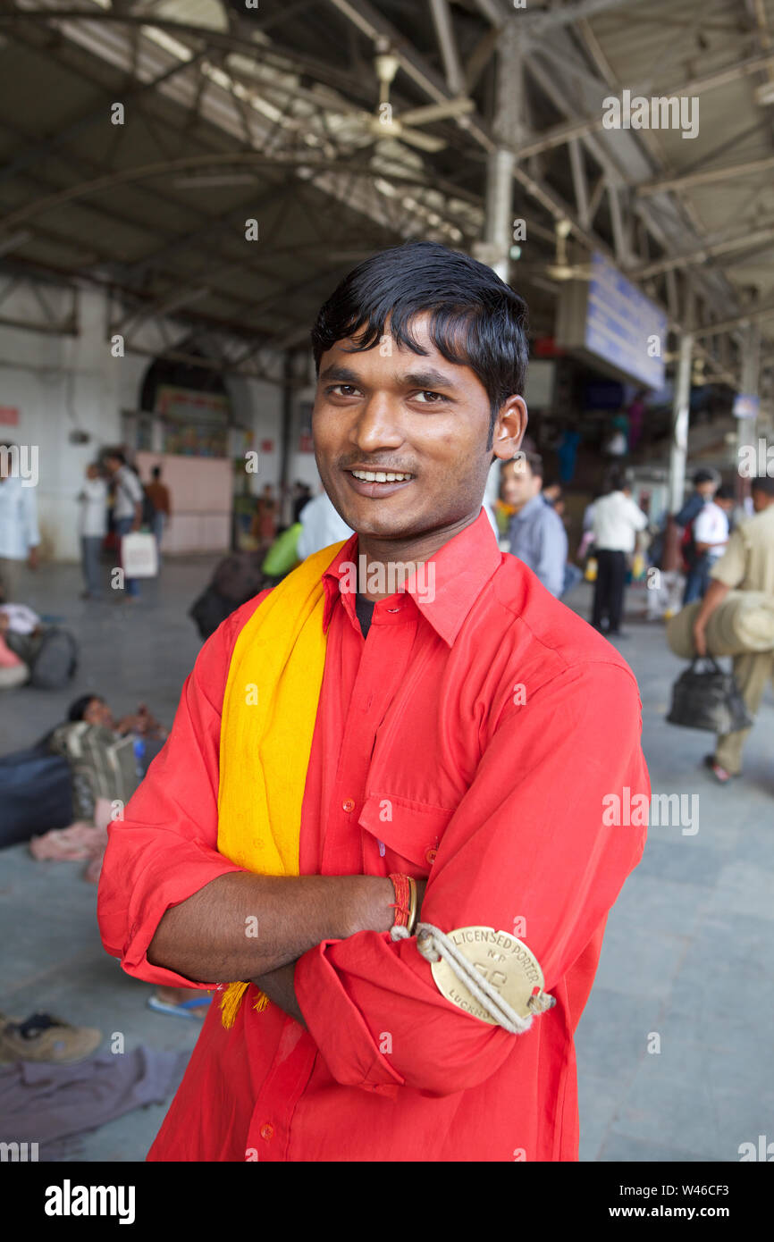 Portrait of a coolie smiling at a station platform Stock Photo - Alamy