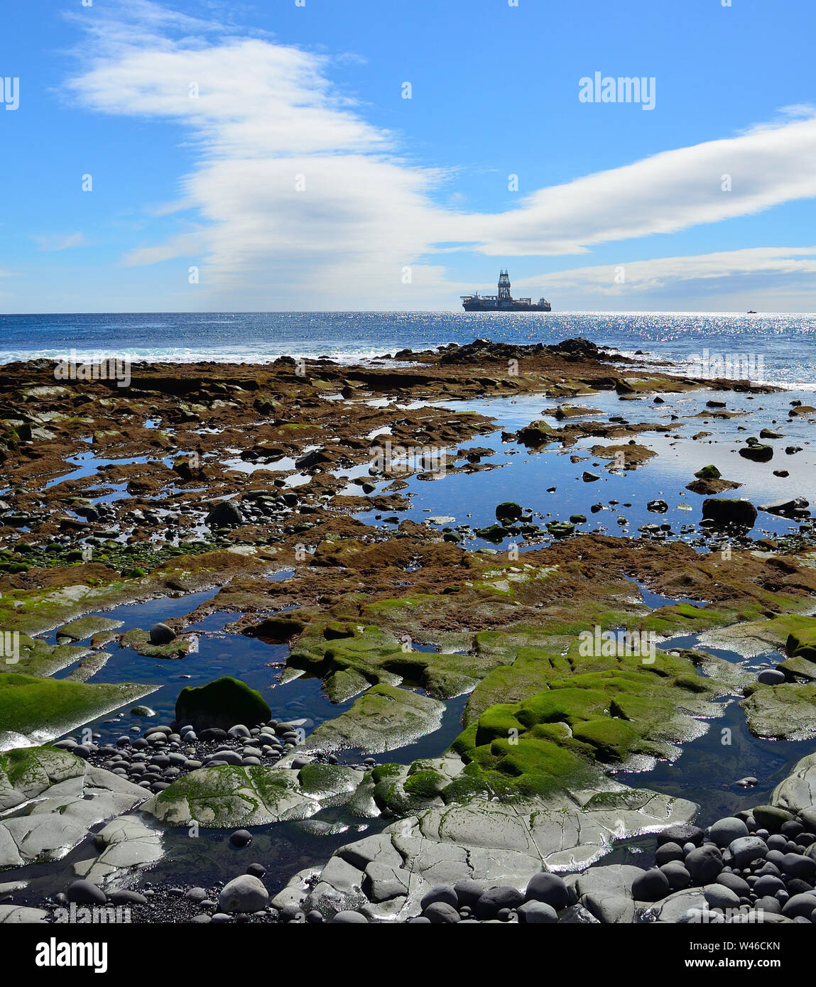 Colorful coast landscape with many water puddles at low tide, blue sky ...