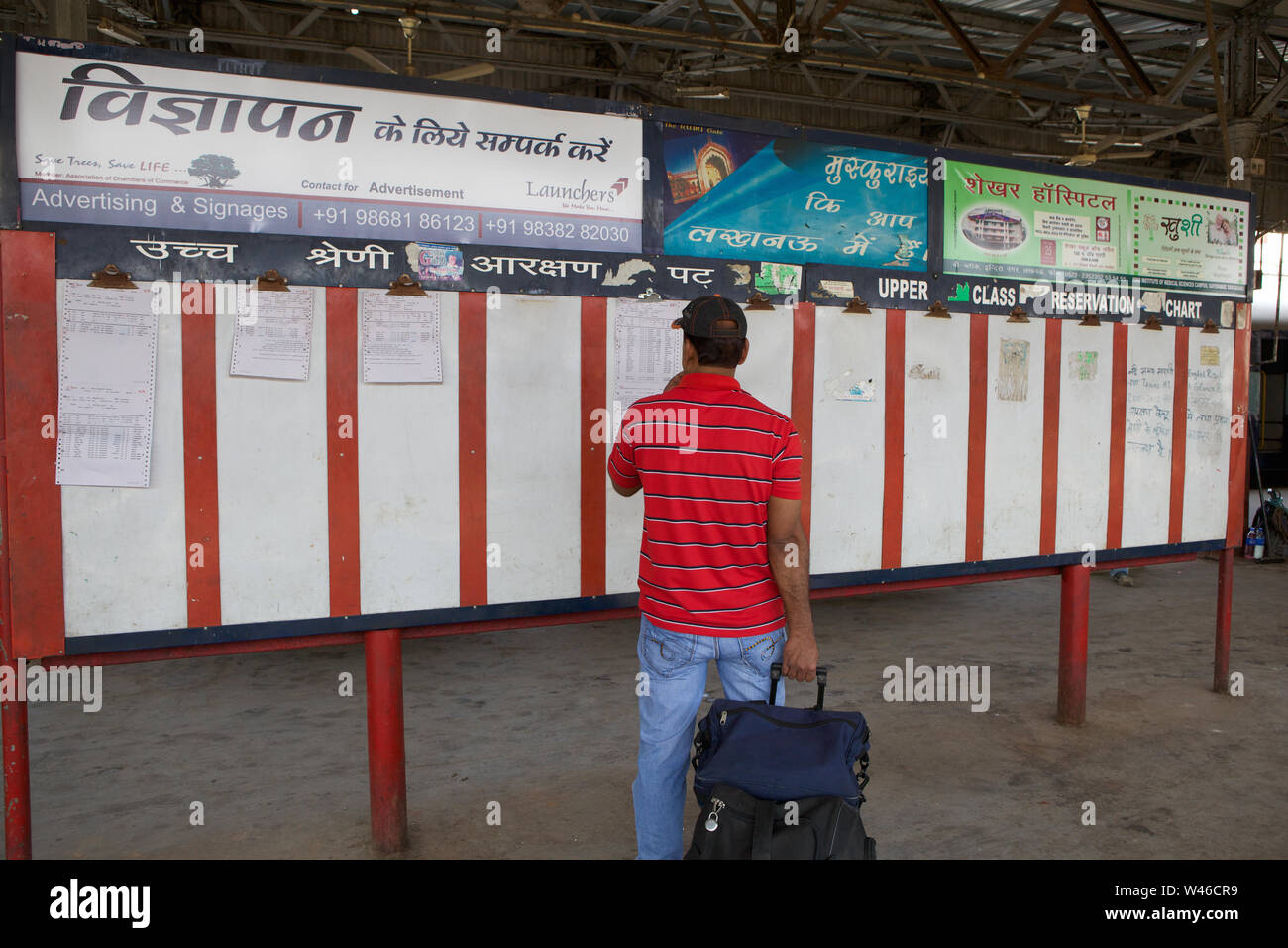 Passenger checking reservation status at a platform, Lucknow, Uttar ...