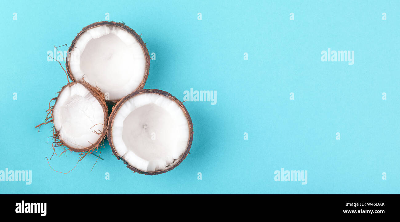 three coconut halves on a blue background, coconut panoramic mock-up ...