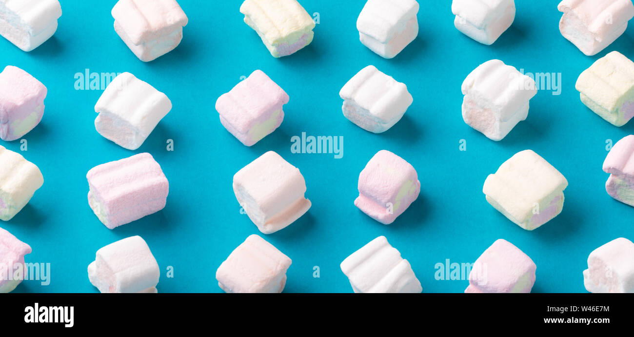 Sweet marshmallows on blue background. Minimalism concept, panoramic ...