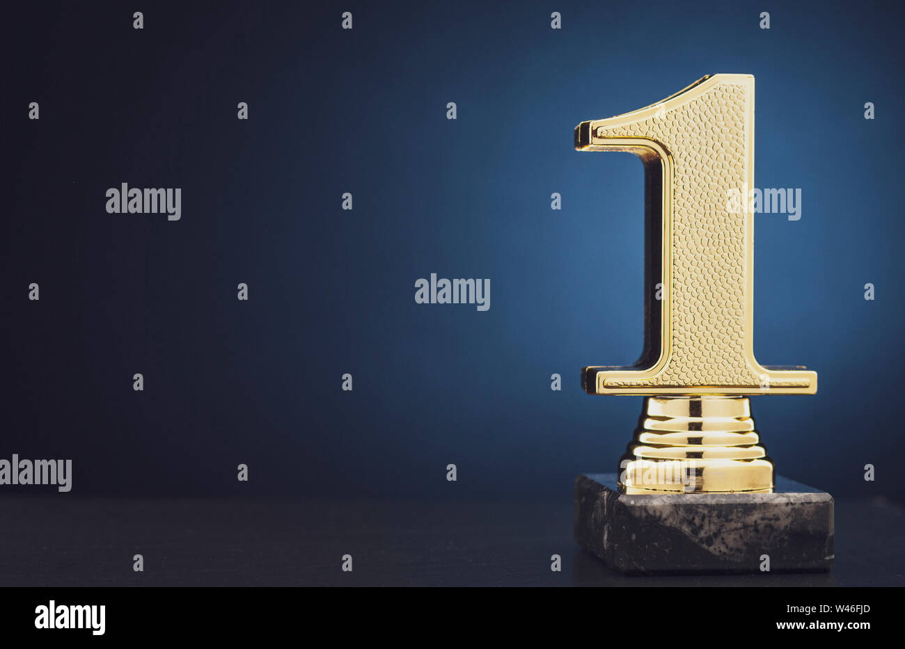 Champion or Winner gold trophy in the shape of a textured 3D number one ...