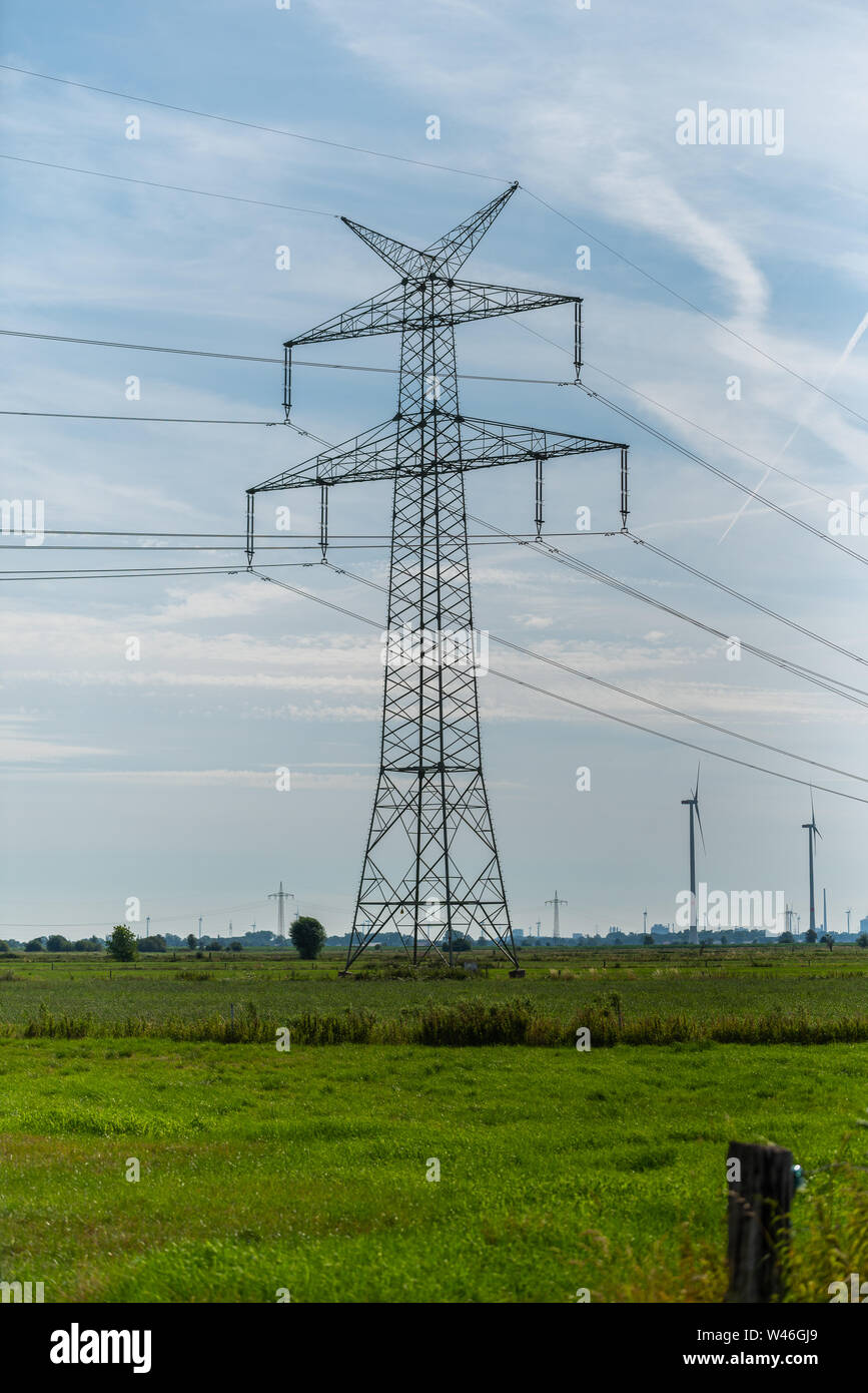 A power pole stands on a free field Stock Photo - Alamy