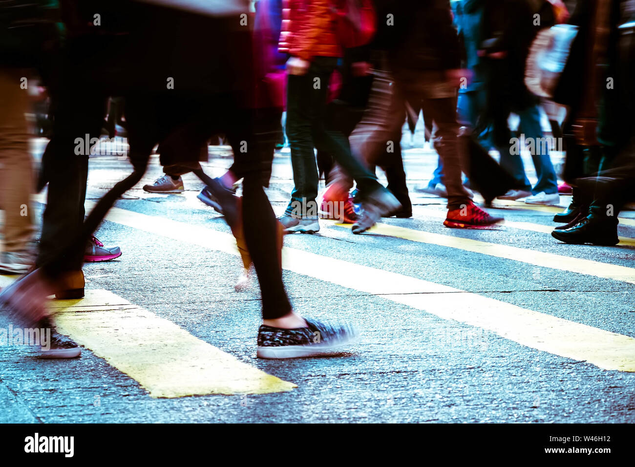 Blurred image of people moving in crowded city street. Art toning ...