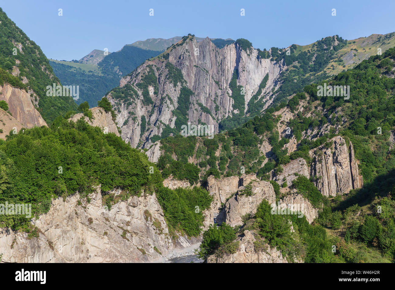 The structure of the rock covered with trees Stock Photo - Alamy