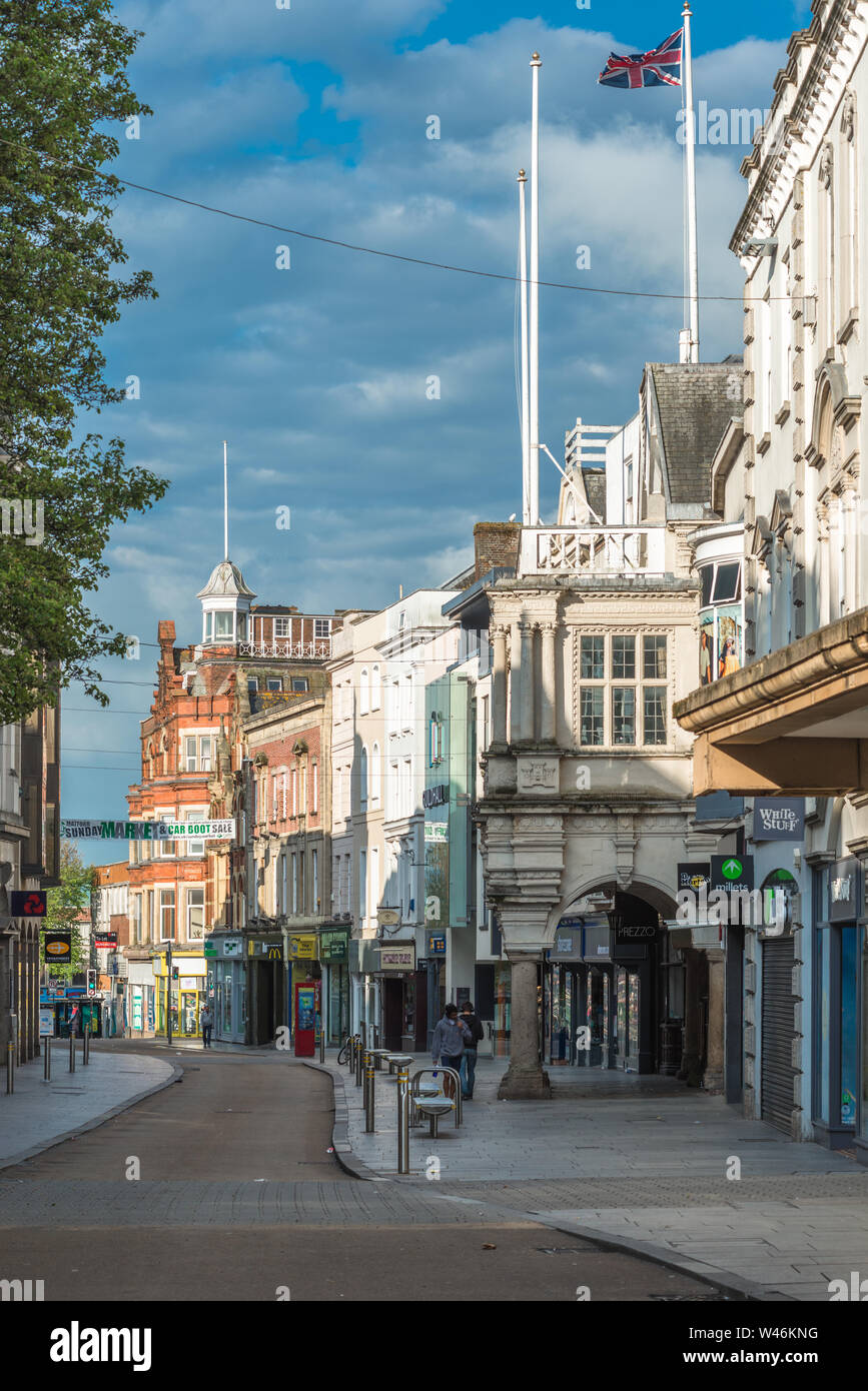 Shops on the High Street in the city centre with the 1596 granite ...