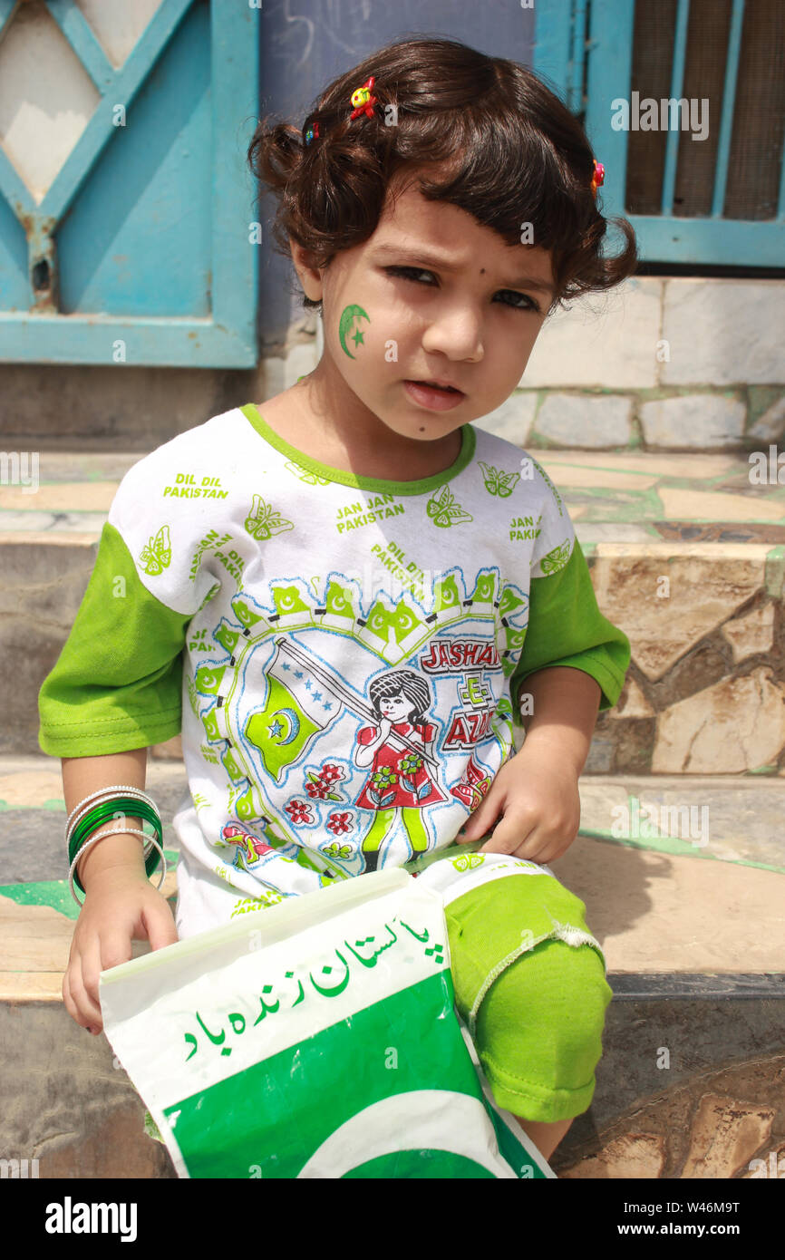 children wearing green and white colors dress and held in hands ...