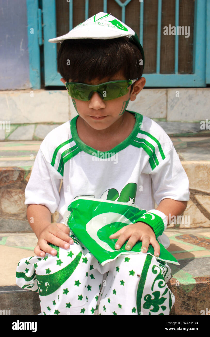 children wearing green and white colors dress and held in hands ...