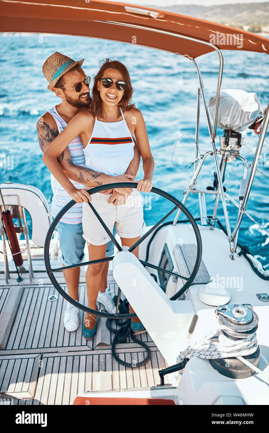 Smiling young couple enjoying a boat ride together Stock Photo - Alamy