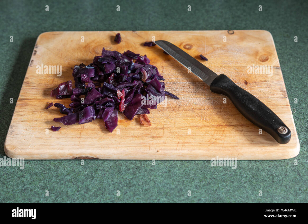 Making red cabbage indicator at home. Red cabbage chopped on a wooden ...