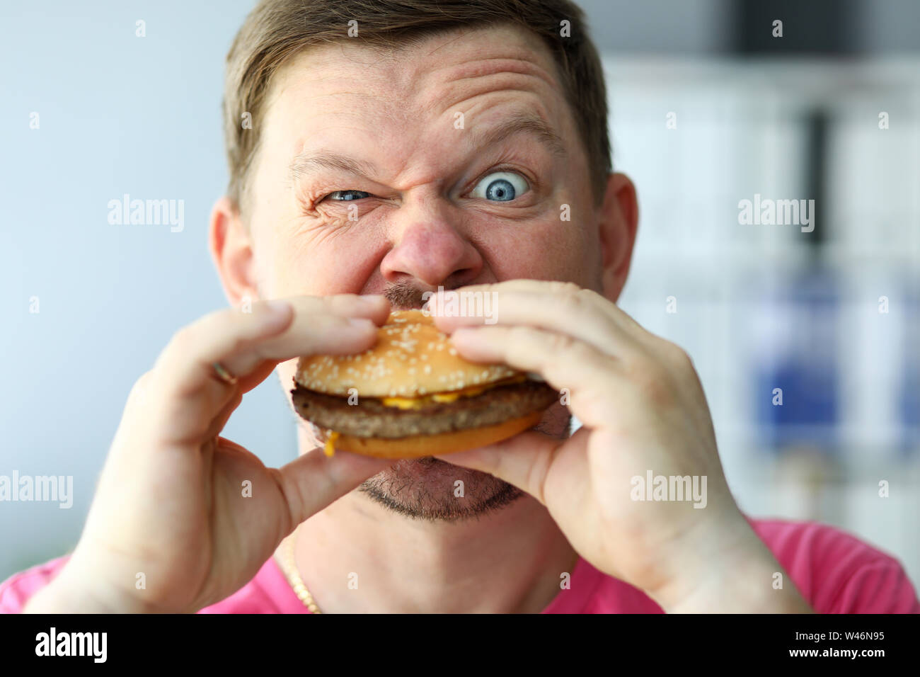 Funny man eating hamburger hi-res stock photography and images - Alamy
