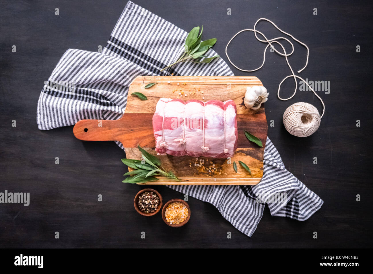 Flat lay. Uncooked boneless pork roast on the cutting board Stock Photo ...