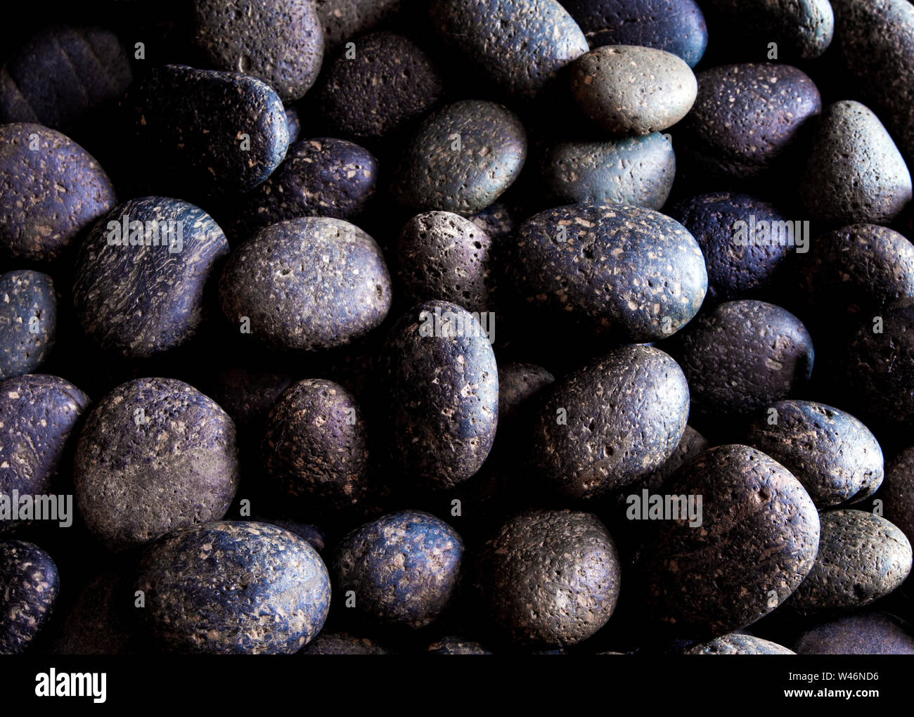 Texture of dried round and spongy black river stone Stock Photo - Alamy