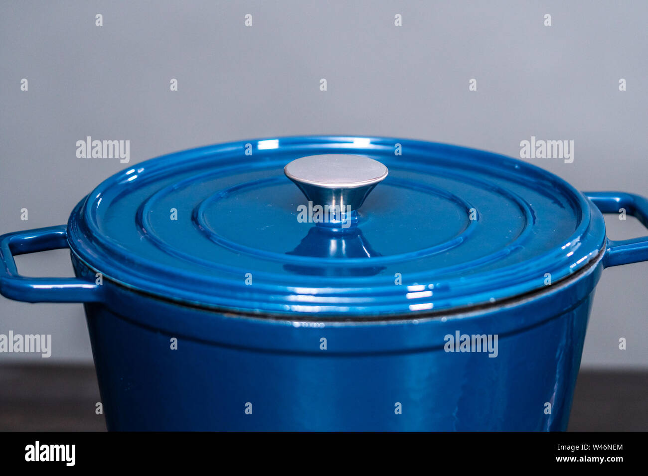 Blue enameled cast iron covered dutch oven with leed Stock Photo - Alamy