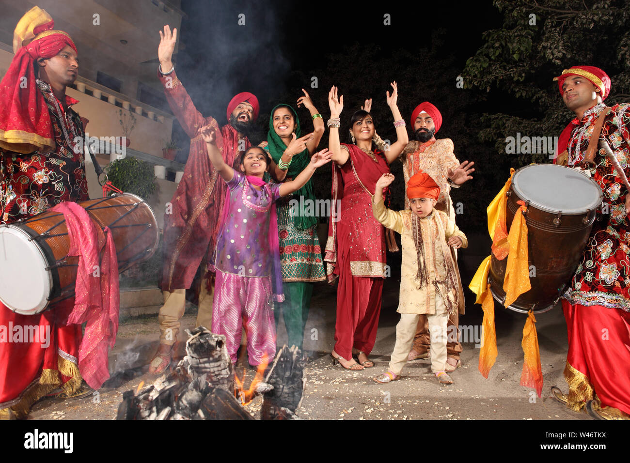 Family celebrating Lohri festival, Punjab, India Stock Photo - Alamy