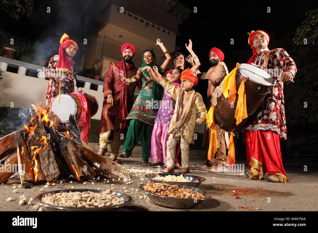 Family celebrating Lohri festival, Punjab, India Stock Photo - Alamy