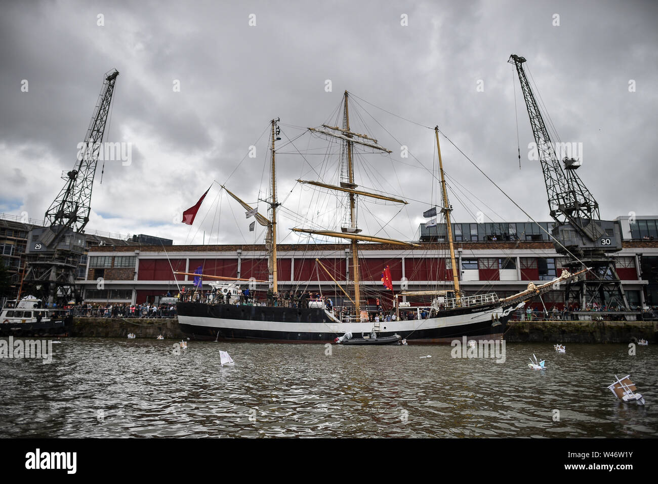 The Pelican of London tall ship sits moored between two dock cranes ...